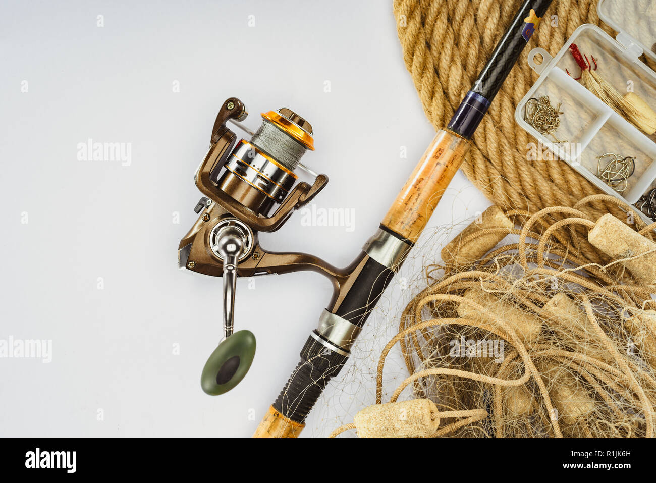 top view of fishing rod, nautical rope and plastic box with fishing ...