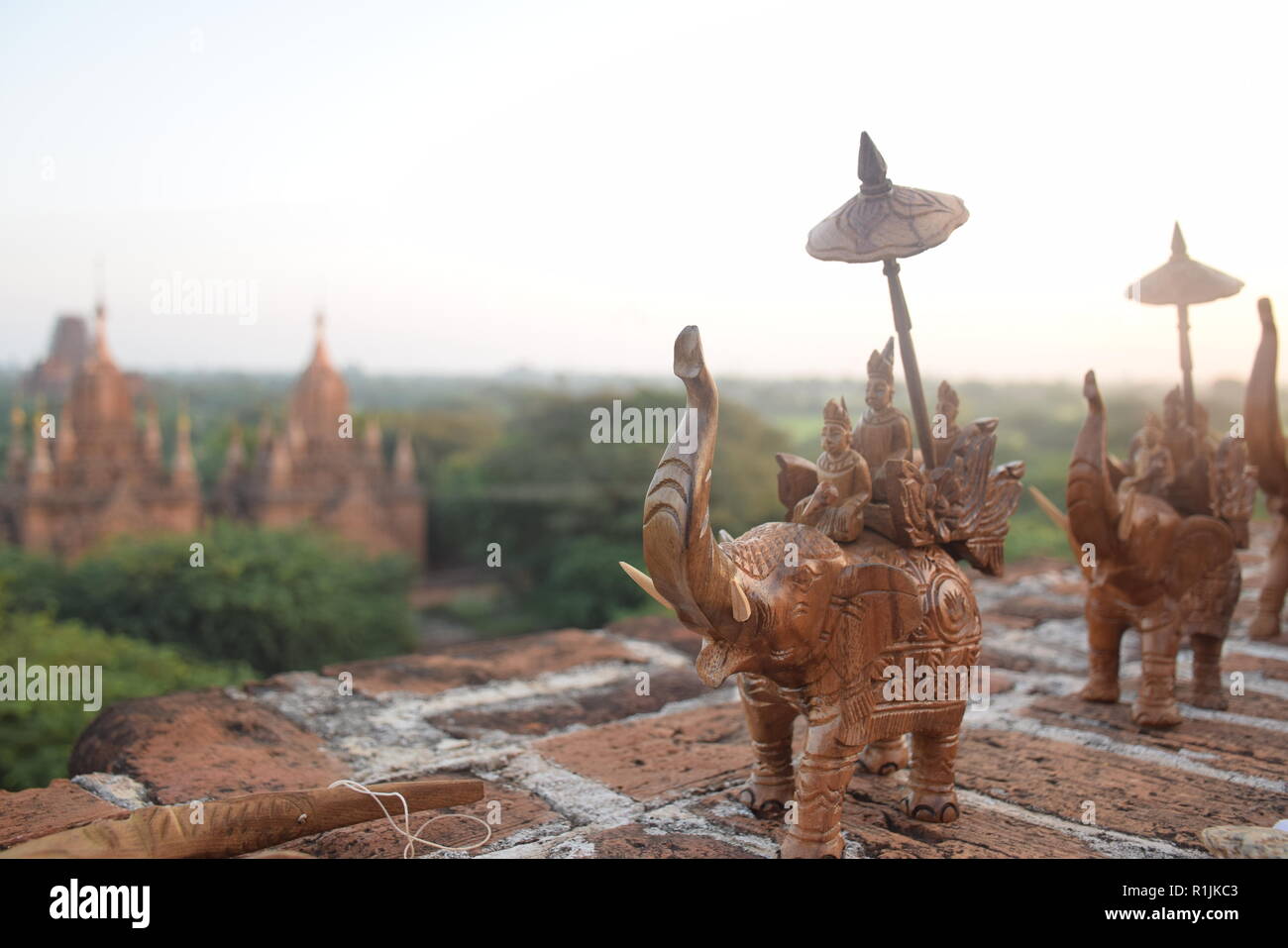 Wooden souvenir of an elephant with the temples of Bagan archaeological ...