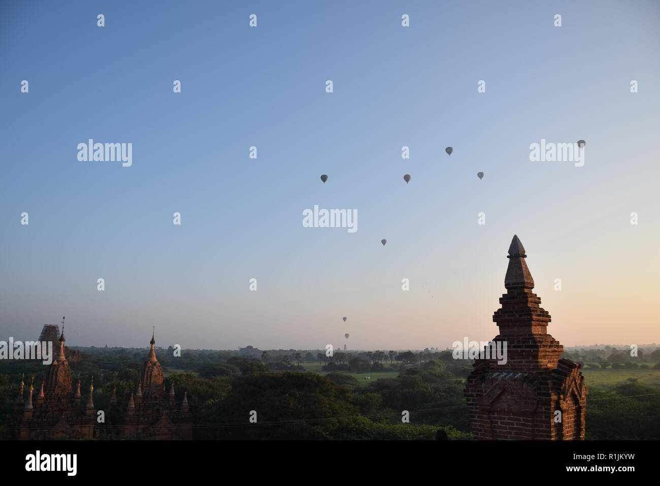 Hot air balloons flying over Bagan archaeological area at sunrise ...