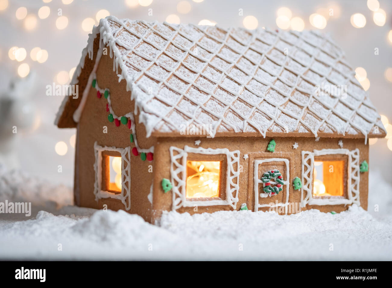 Gingerbread house in snow with twinkling silver light background Stock ...