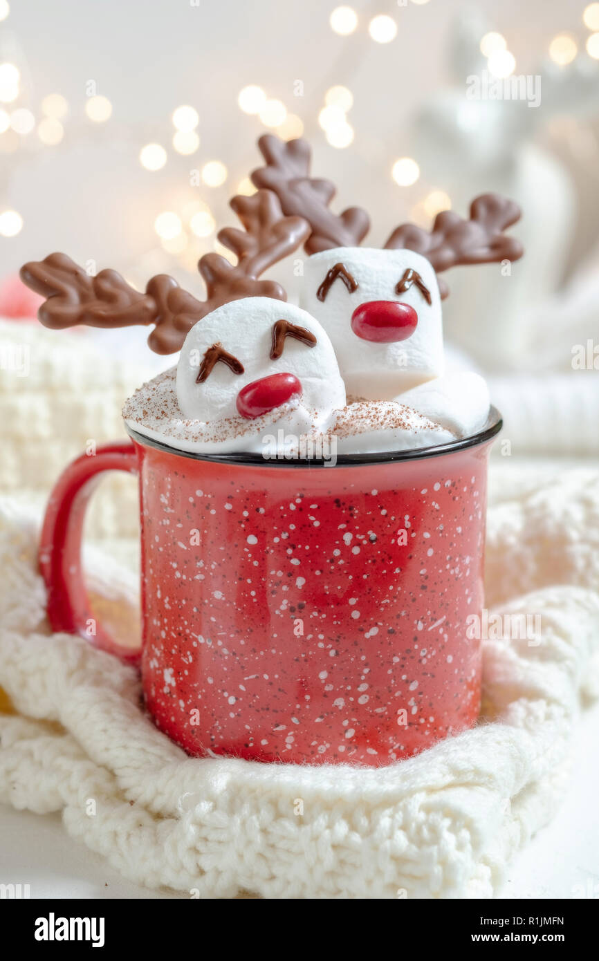 Red mug with hot chocolate with melted marshmallow reindeer Stock Photo ...