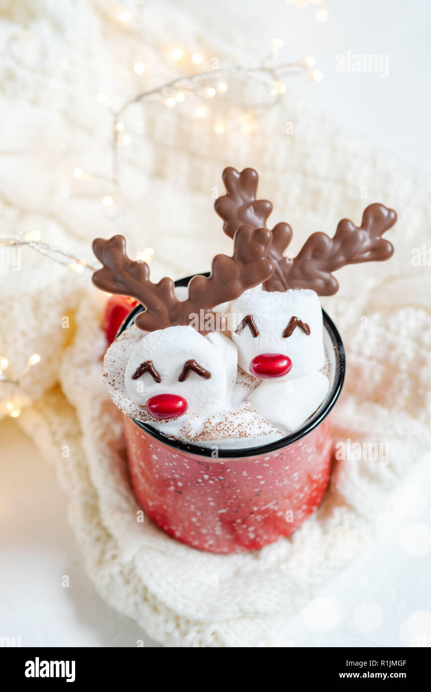 Red mug with hot chocolate with melted marshmallow reindeer Stock Photo ...