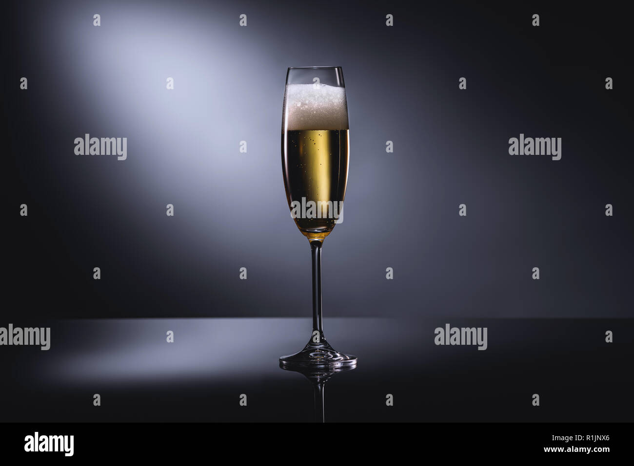 close up view of glass of champagne with foam on dark backdrop Stock ...