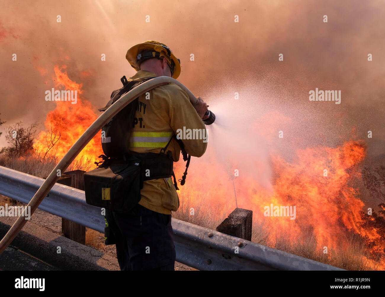 Simi Valley, California, USA. 12th Nov 2018. A firefighter battles ...