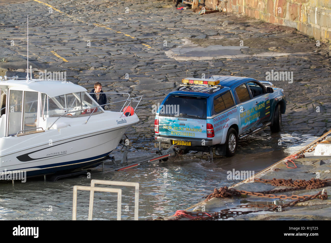 New Quay,UK,13th November 2018, UK Weather: A 4x4 vehicle helps pull a ...