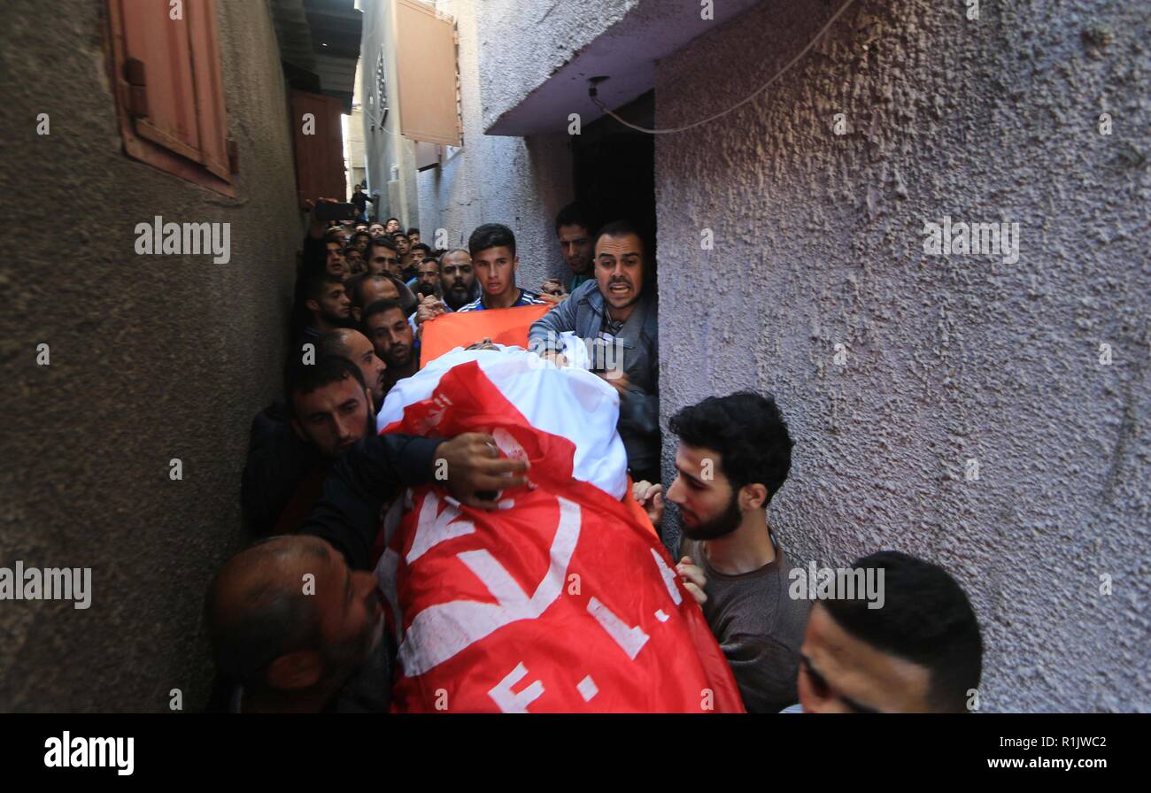Jabalia, Gaza Strip, Palestinian Territory. 13th Nov, 2018. Mourners carry the body of ...