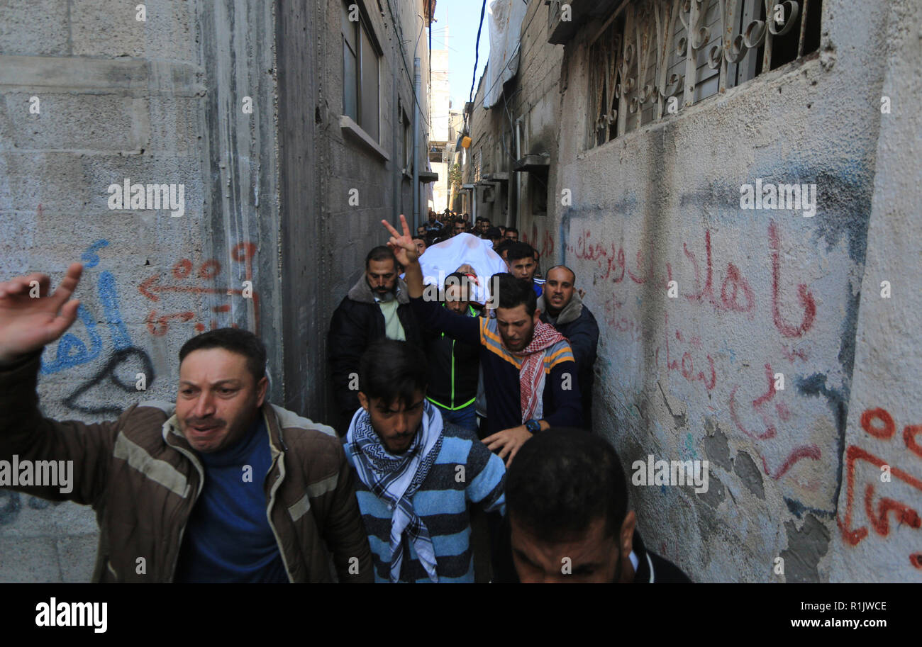 Jabalia, Gaza Strip, Palestinian Territory. 13th Nov, 2018. Mourners carry the body of ...