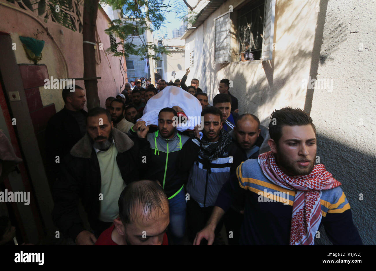 Jabalia, Gaza Strip, Palestinian Territory. 13th Nov, 2018. Mourners carry the body of ...