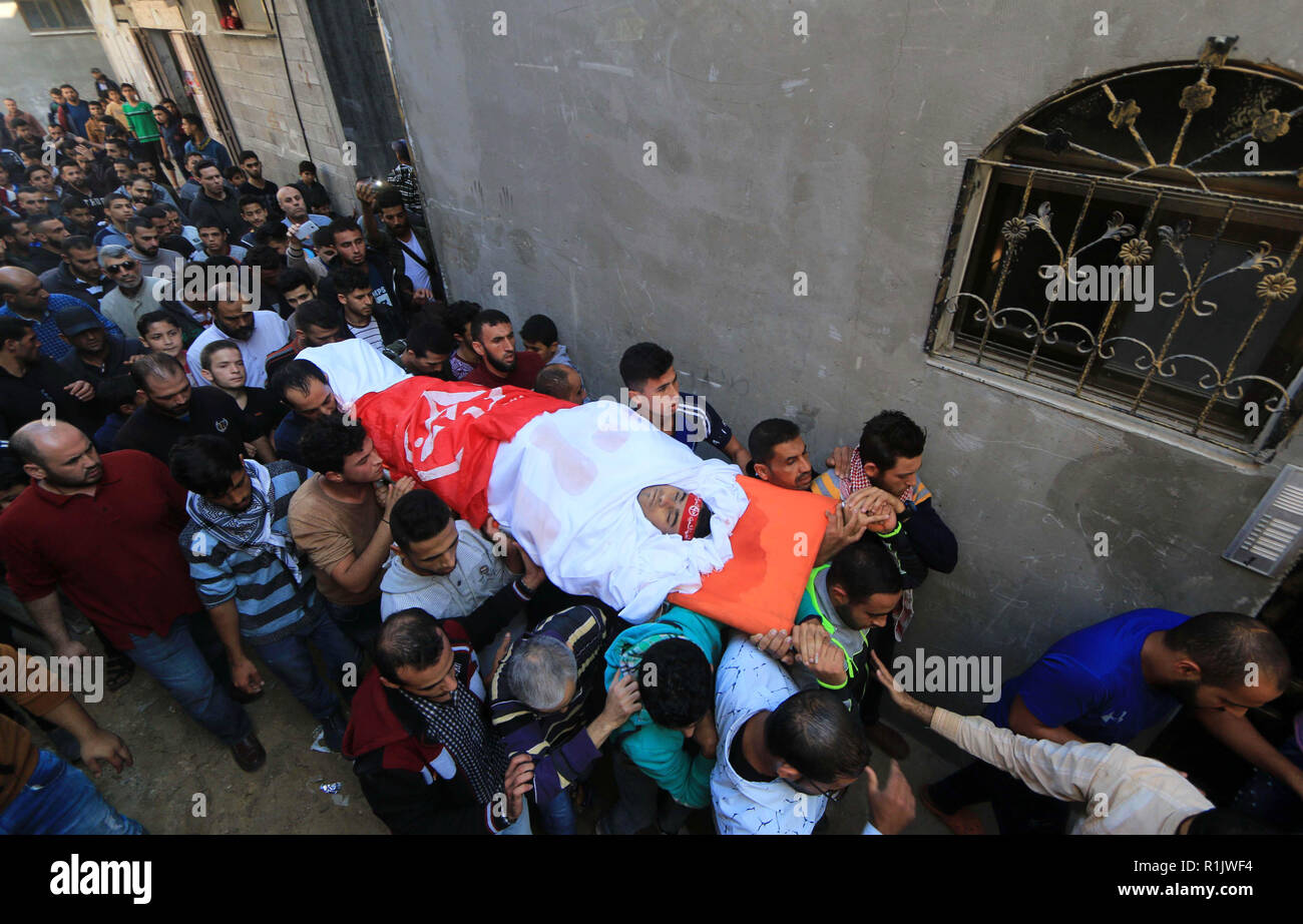 Jabalia, Gaza Strip, Palestinian Territory. 13th Nov, 2018. Mourners carry the body of ...