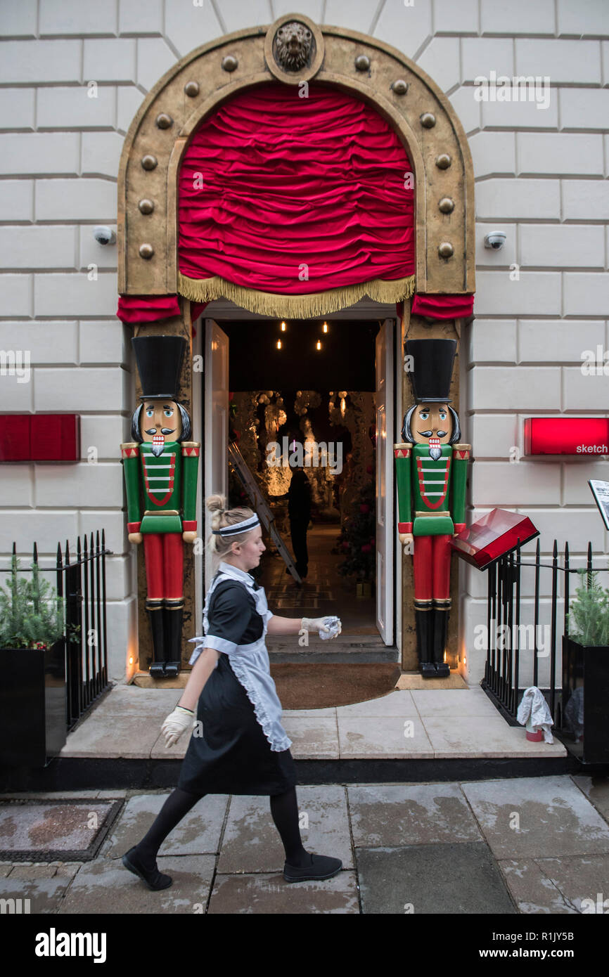 London, UK. 13th Nov 2018. A cleaner prepares the Nutcracker, Christmas ...