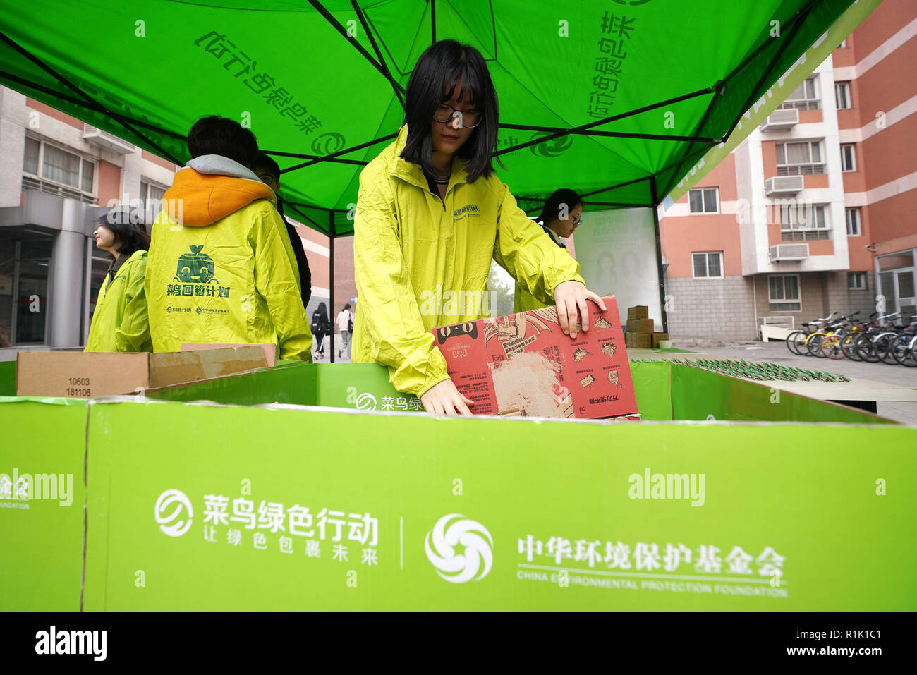 Beijing, China. 13th Nov, 2018. Volunteers collect parcel packagings at ...