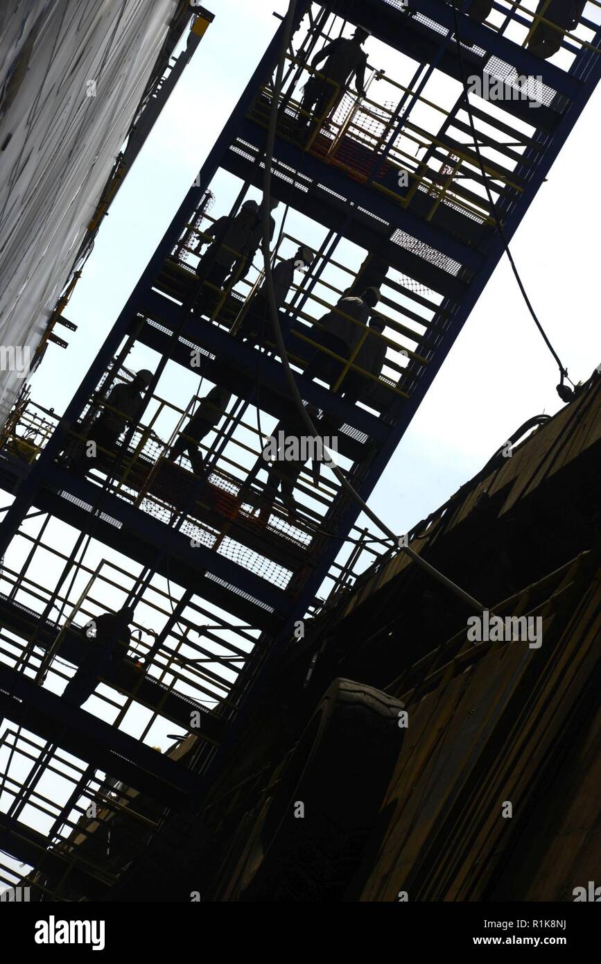 Workers make their way along scaffolding during a lunchbreak aboard the ...