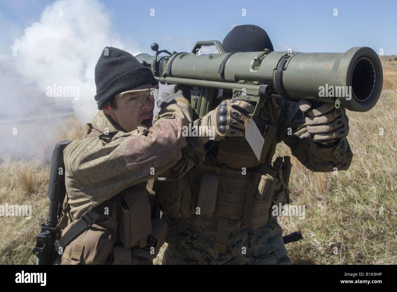 New Zealand Army Lance Cpl. Jonathan Sorenson assists U.S. Marine Cpl ...