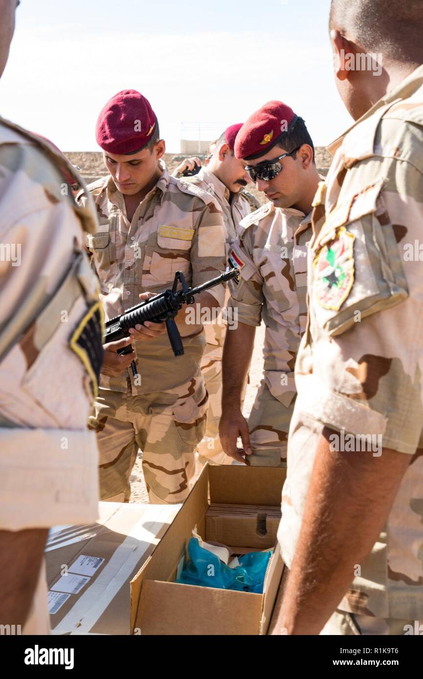 Iraqi Army soldiers from 59th Brigade inspect a rifle that has just ...