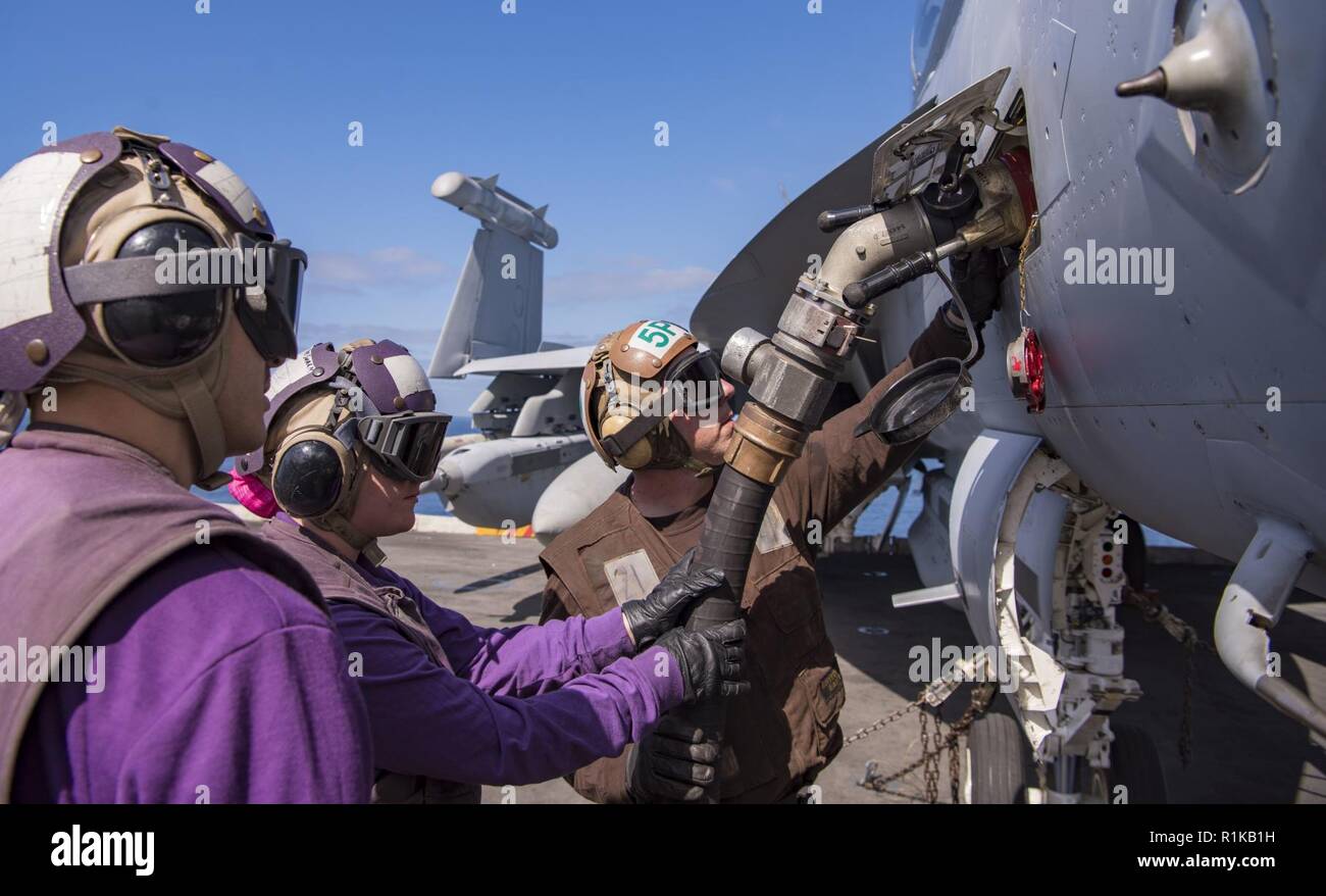 PACIFIC OCEAN (Oct. 09, 2018) Sailors fuel an EA-18G Growler assigned ...