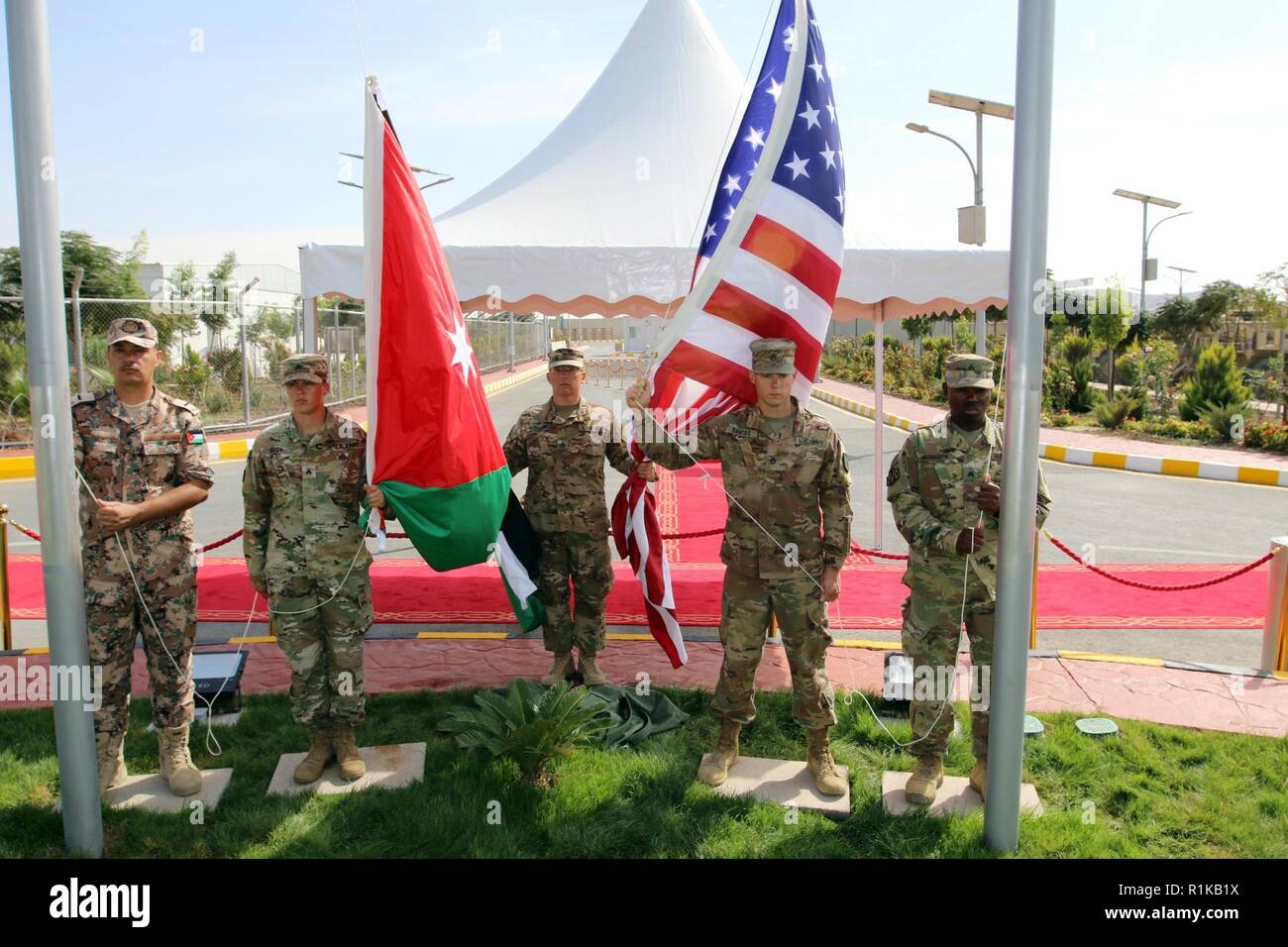 AMMAN, Jordan – A flag-raising detail stands ready during a dedication ...