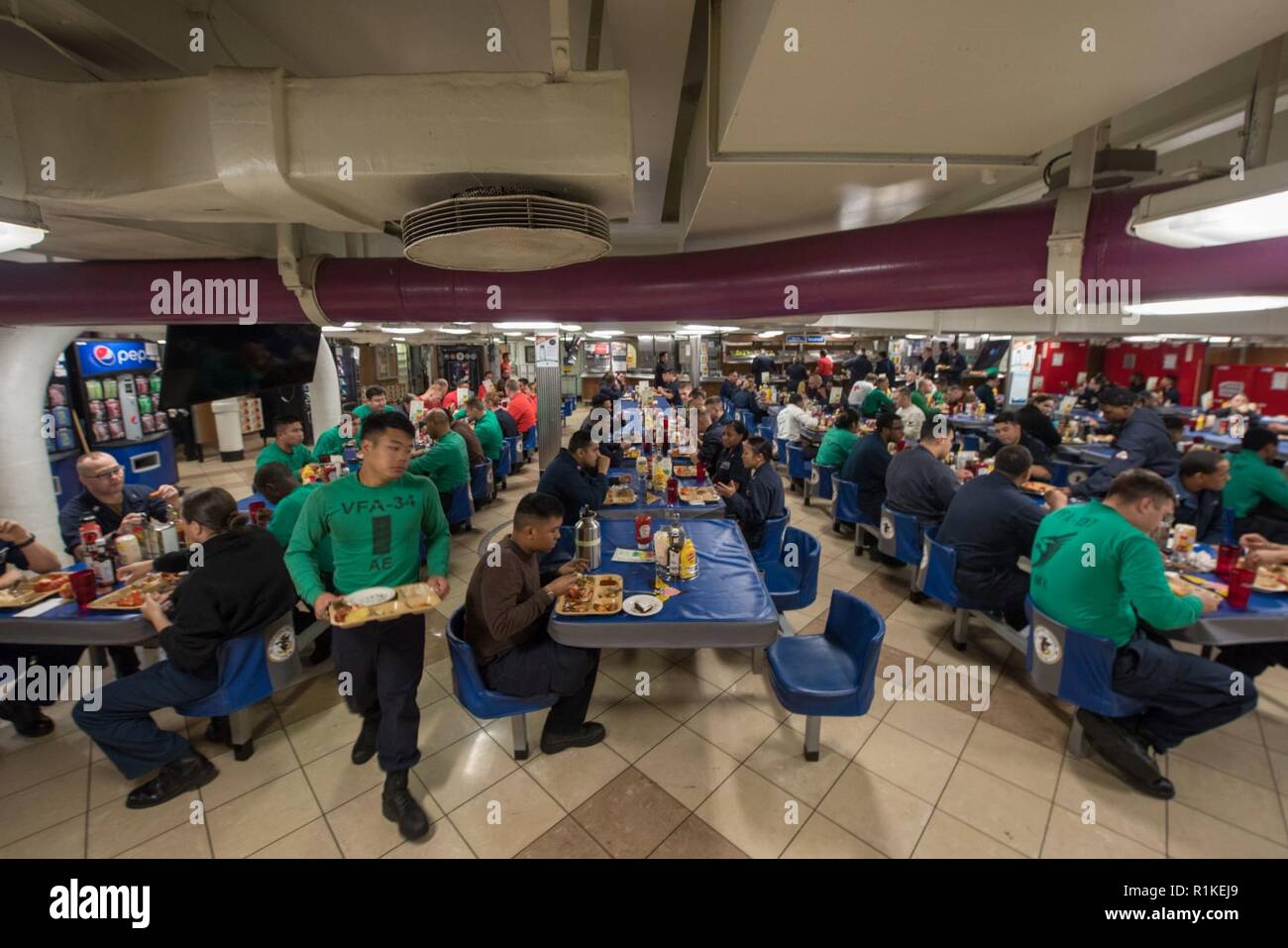 PACIFIC OCEAN (Oct. 13, 2018) Sailors eat lunch on the mess deck aboard ...