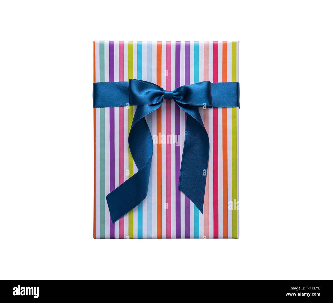Gift in a bright striped wrapping paper Stock Photo - Alamy