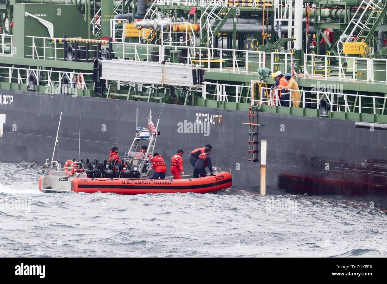 Members of the Coast Guard Cutter Legare use a deployable small boat to ...