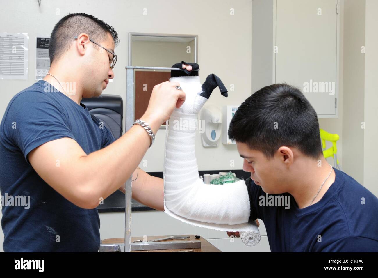 Hospital Corpsman 3rd Class Darren Cason, from Fallon, Nevada, applies ...