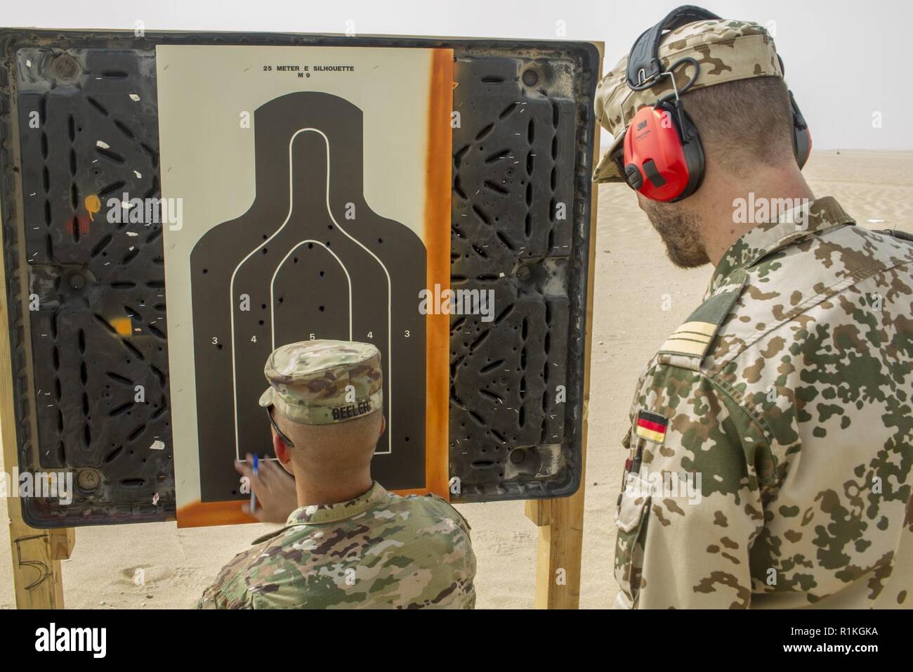 U.S. Army Master Sgt. Bryan C. Beeler scores a target during the M9 ...
