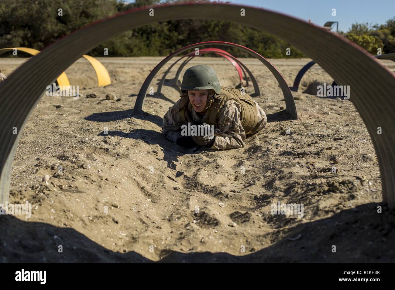 A recruit from Lima Company, 3rd Recruit Training Battalion, crawls ...