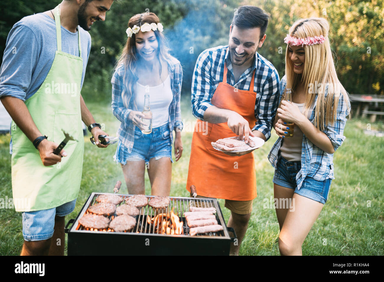 Friends spending time in nature and having barbecue Stock Photo - Alamy
