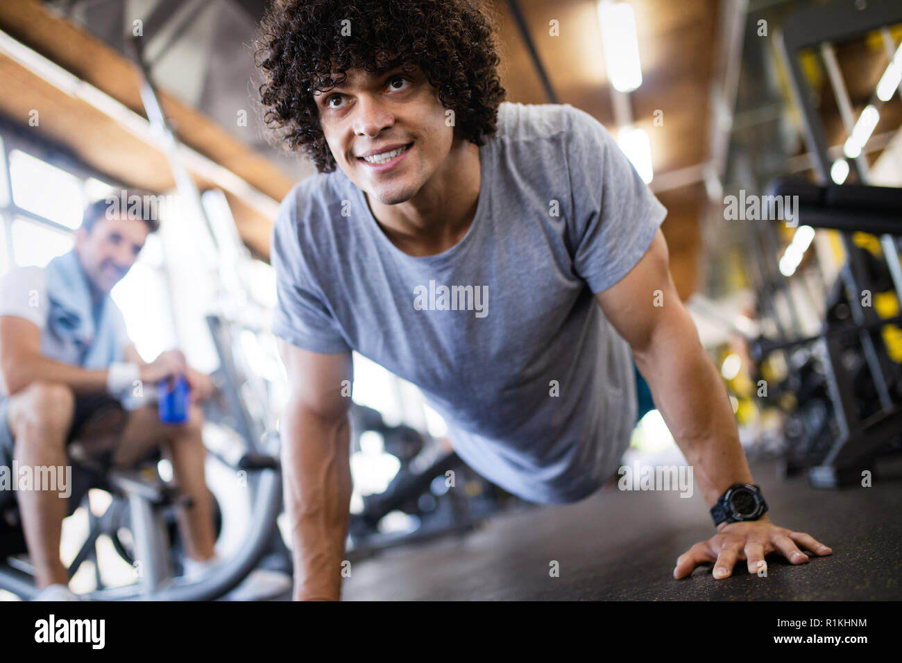 Portrait of a handsome man doing push ups exercise in gym Stock Photo ...