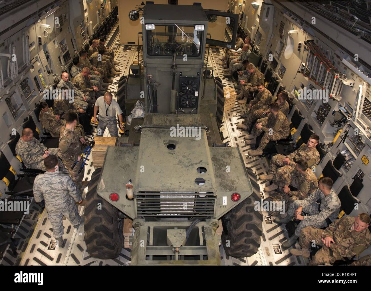 Airmen from the 635th Materiel Maintenance Group board a C-17 ...