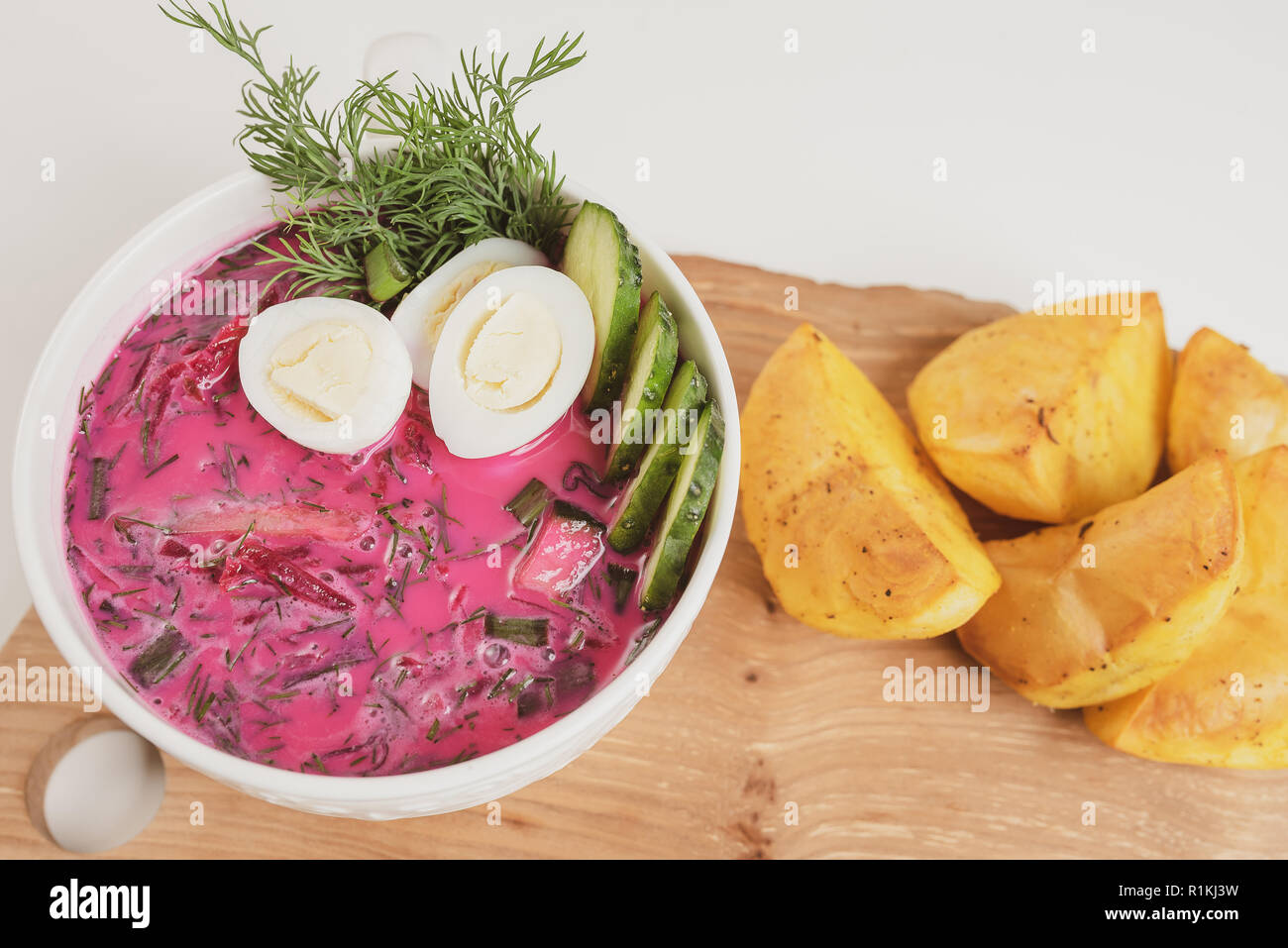 Lithuanian cold beet soup (Saltibarsciai). Placed on wooden board ...