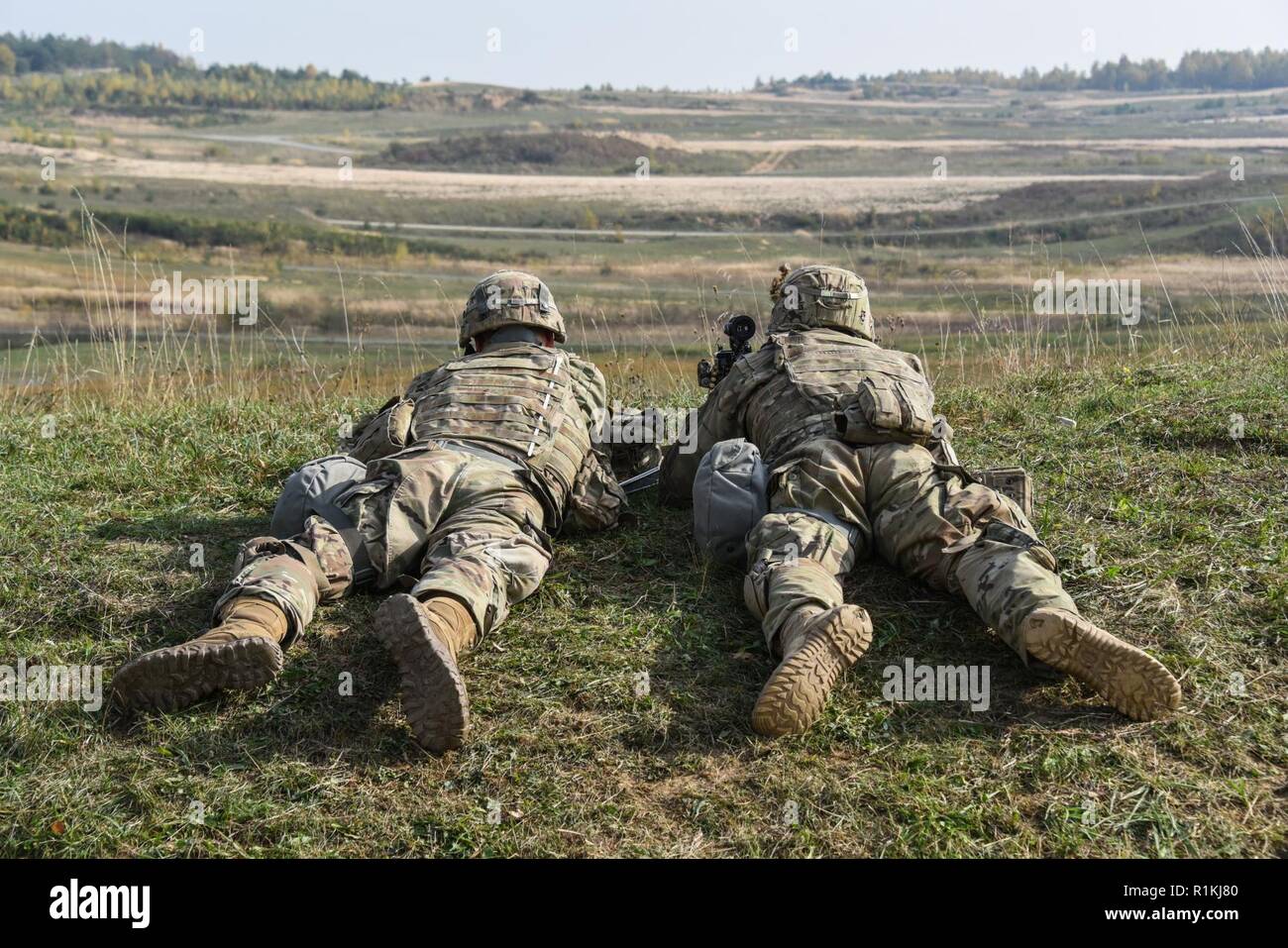 U.S. Soldiers assigned to 2nd Cavalry Regiment (2CR) scan the range ...
