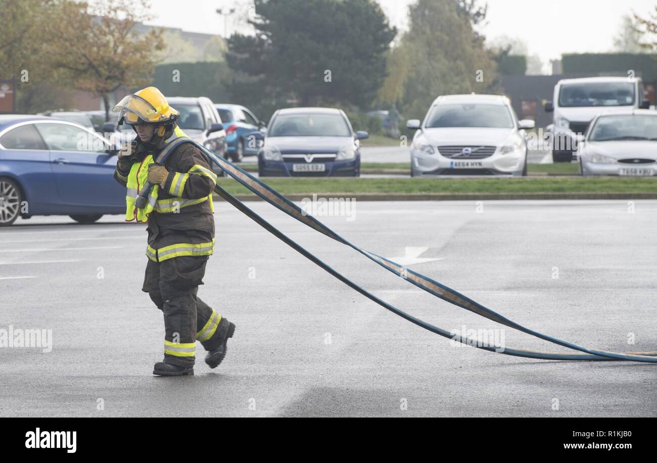 A firefighter, with the 423rd Civil Engineer Squadron, secures fire ...