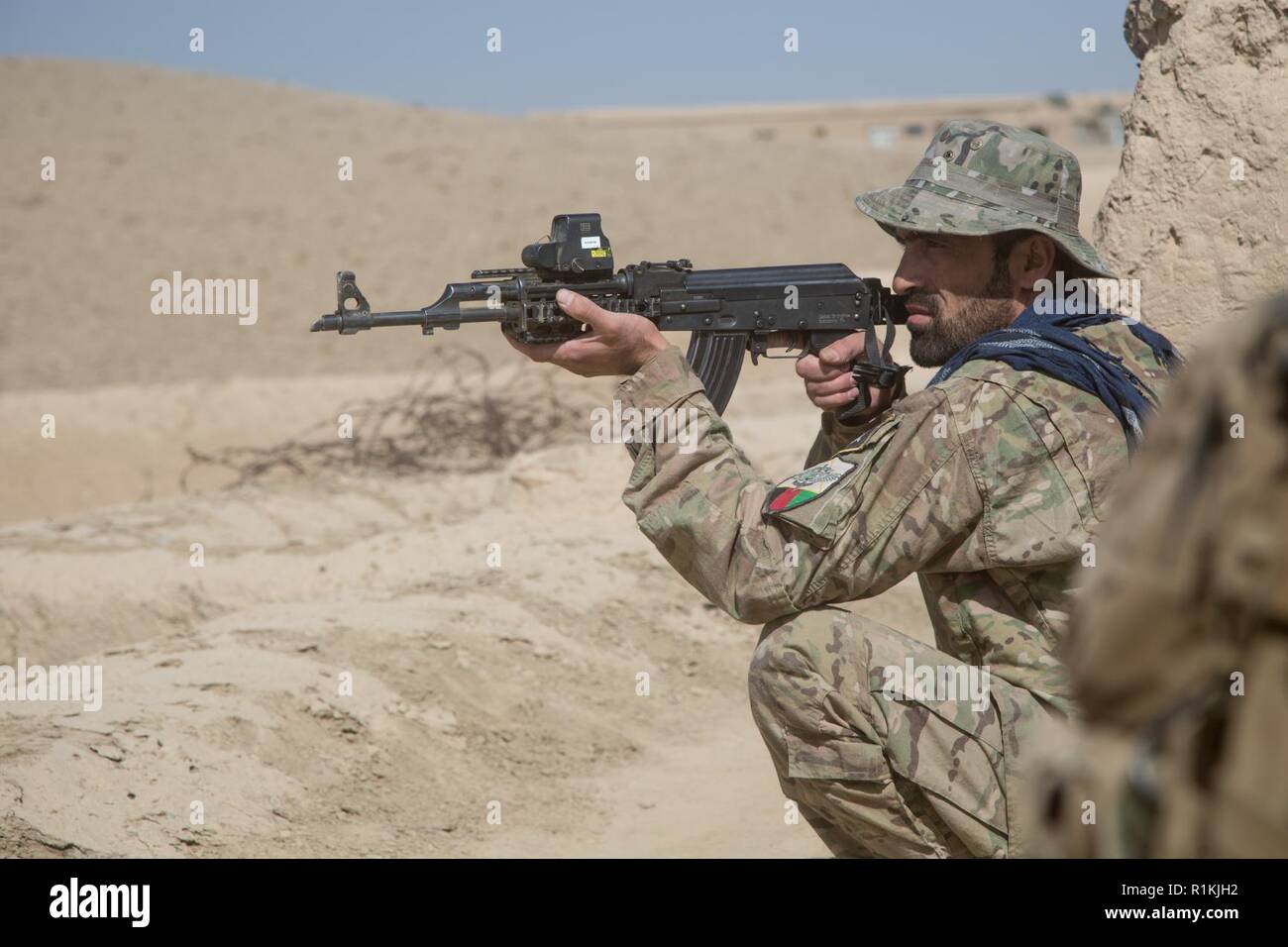 LOGAR, Afghanistan -- An Afghan special operator stands watch as Afghan ...