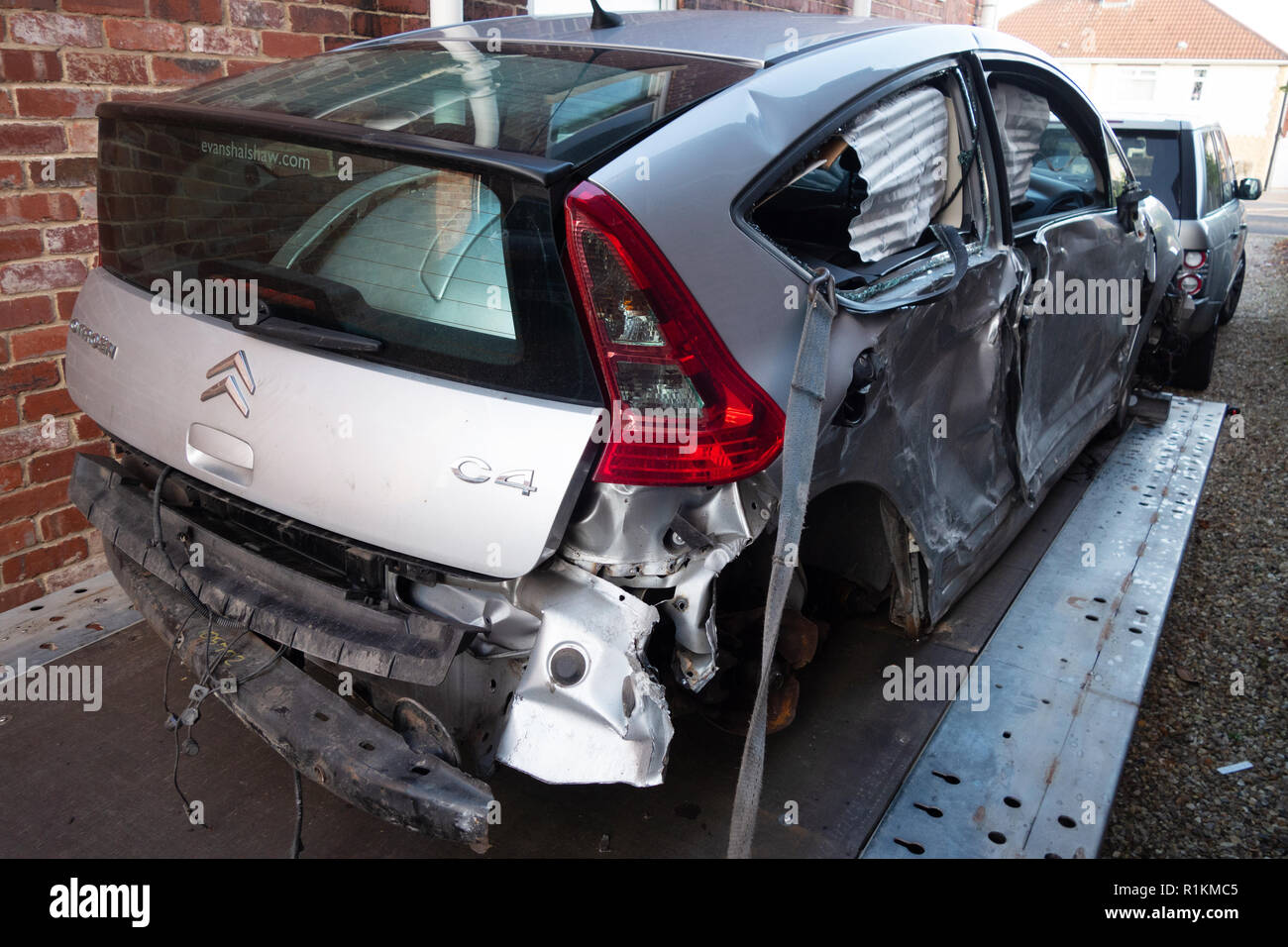three quarter rear view of written off crash damaged citroen c4 car on ...