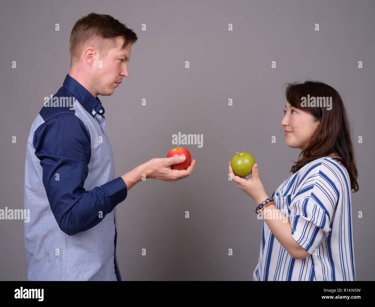 Ethnic male holding an apple hi-res stock photography and images - Alamy