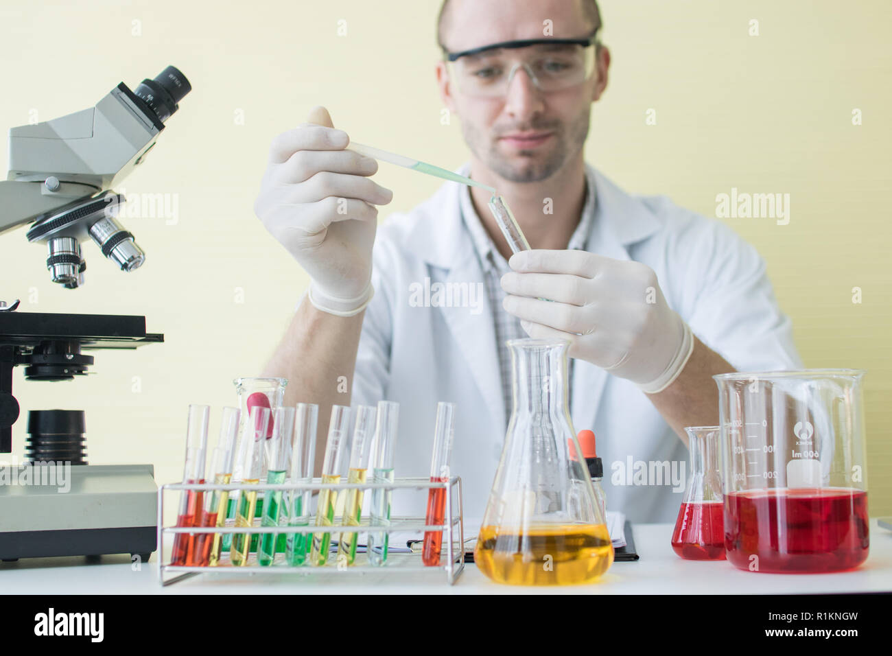 scientist holding test tube in science lap Stock Photo - Alamy