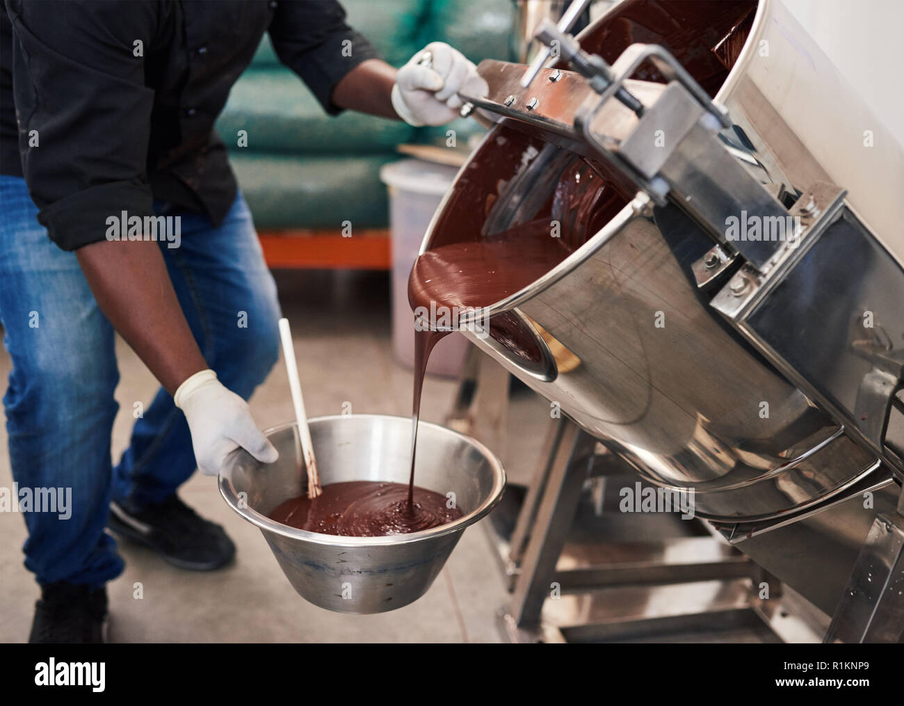 Worker melting chocolate while at work in a confectionary factory Stock ...
