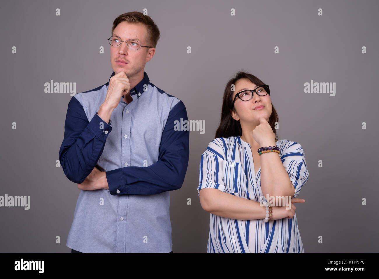 Portrait of confident multi ethnic diverse couple thinking Stock Photo ...