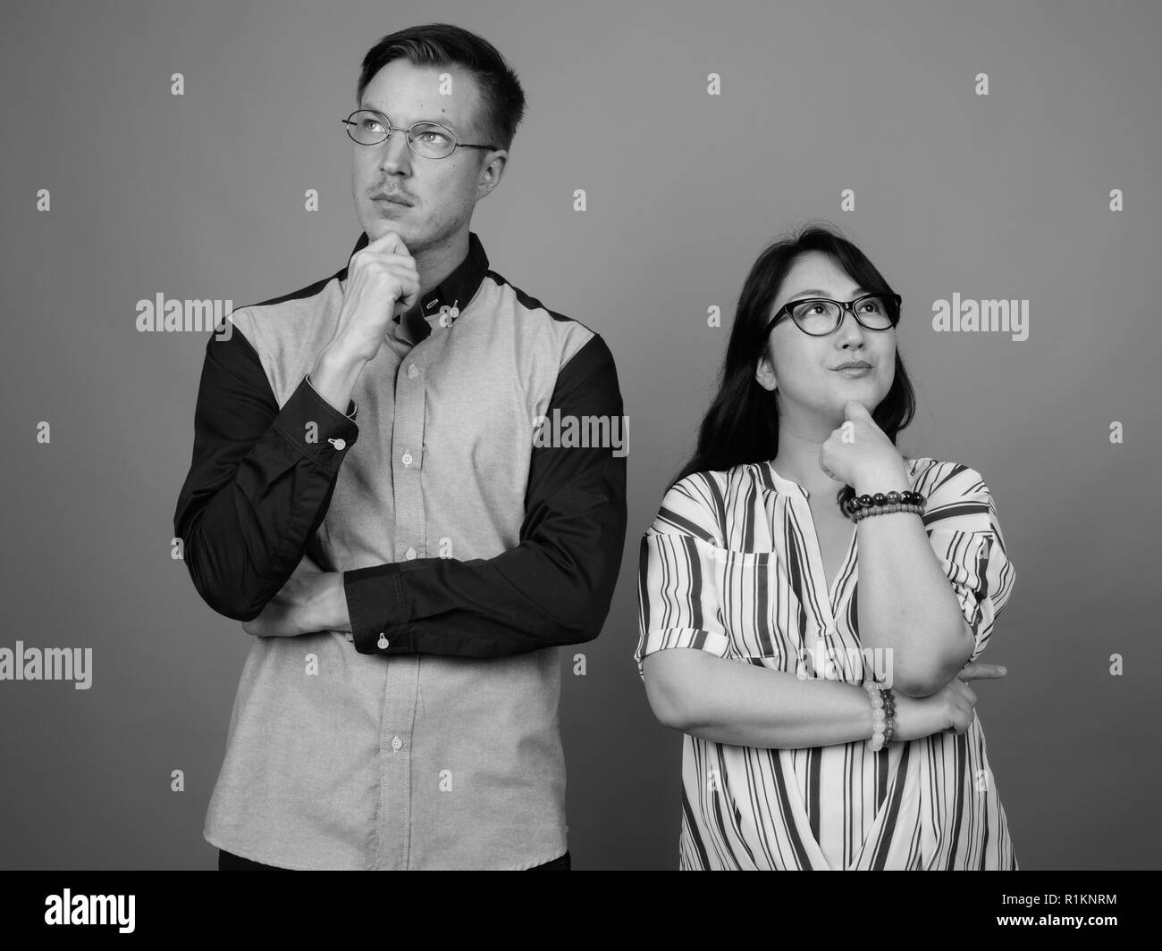 Portrait of confident multi ethnic diverse couple thinking Stock Photo ...