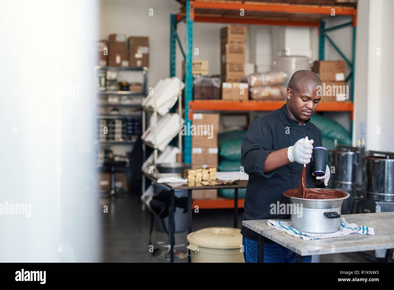 Worker melting and mixing chocolate in a bowl Stock Photo - Alamy