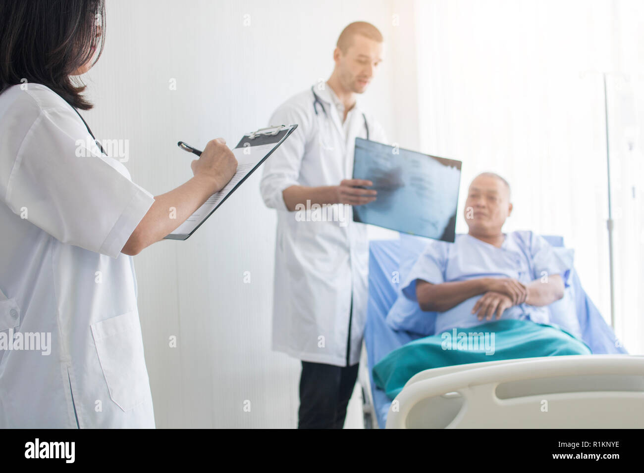 Healthcare and medical people concept, doctor looking on X-ray film of ...