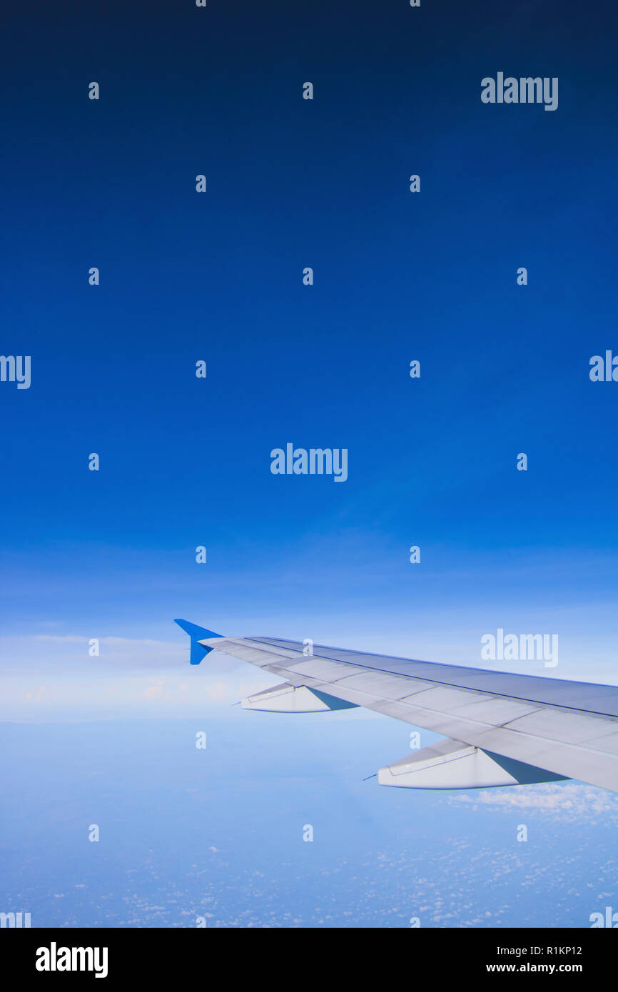 top view blue sky with wing of airplane Stock Photo - Alamy