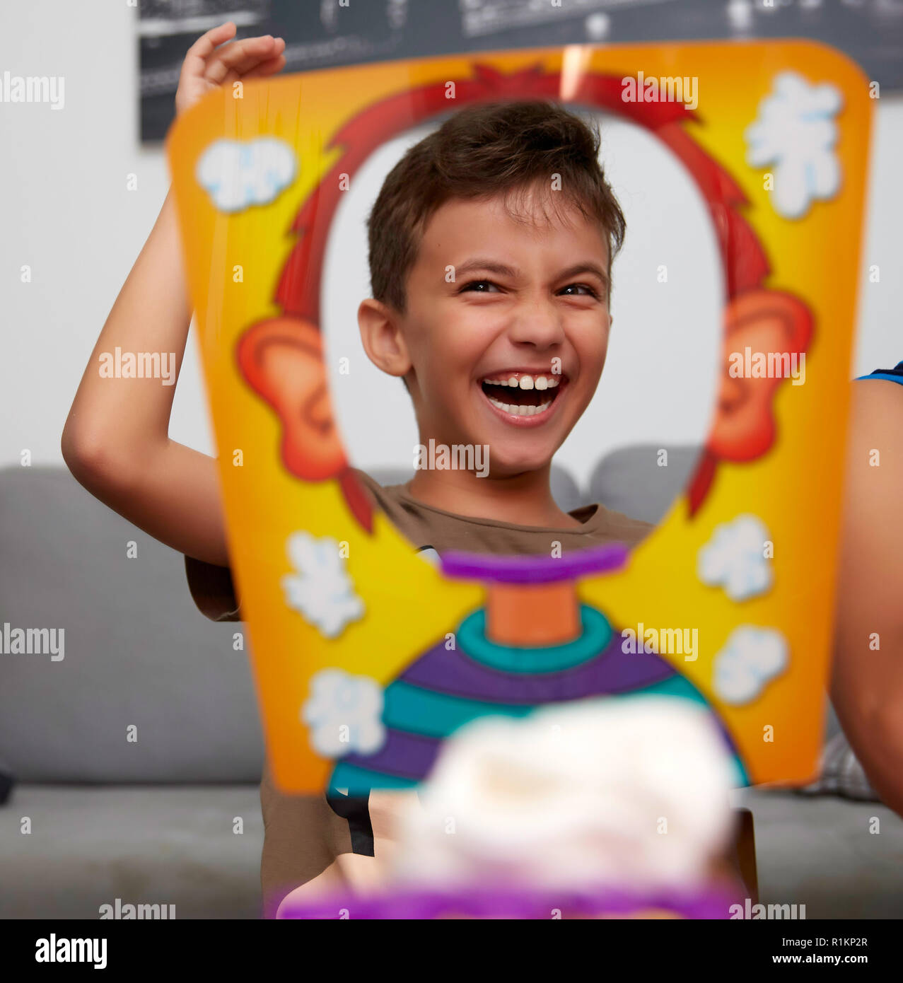 Boy is laughing loudly in cafe Stock Photo - Alamy