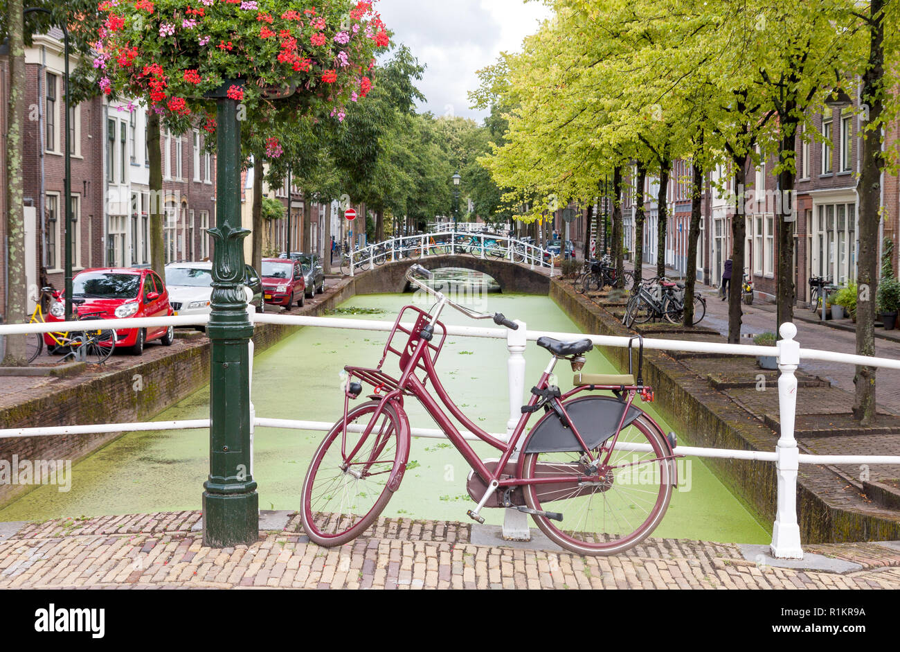 Delft city view in the Netherlands with water canal and vintage bicycle ...