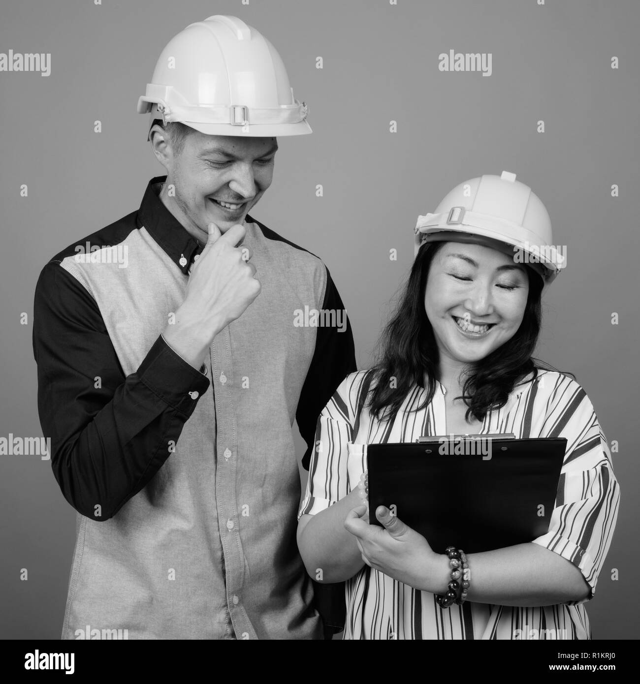 Smiling engineer wearing white Black and White Stock Photos & Images ...