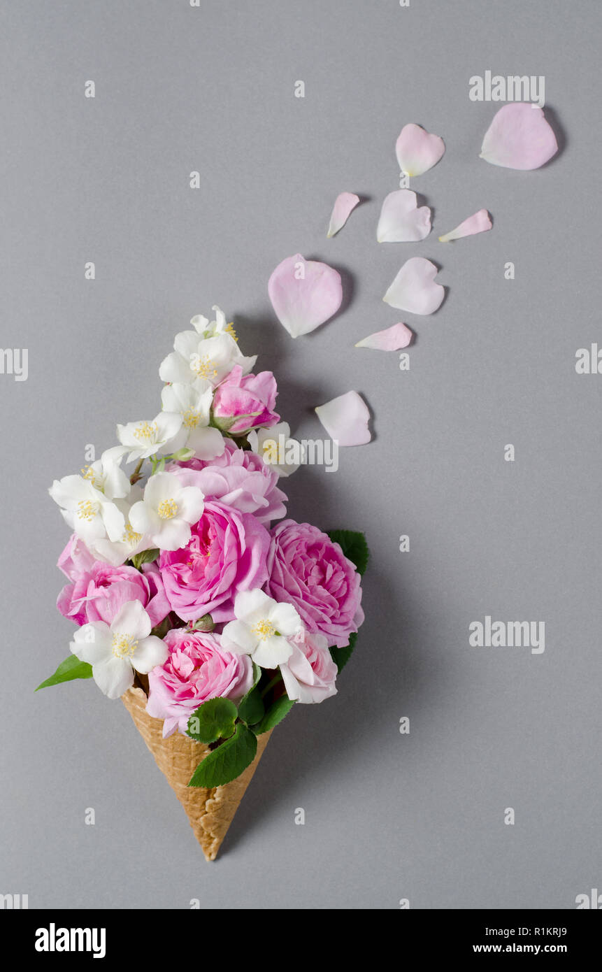 Fresh spring roses in waffle cone. Beautiful romantic background in ...