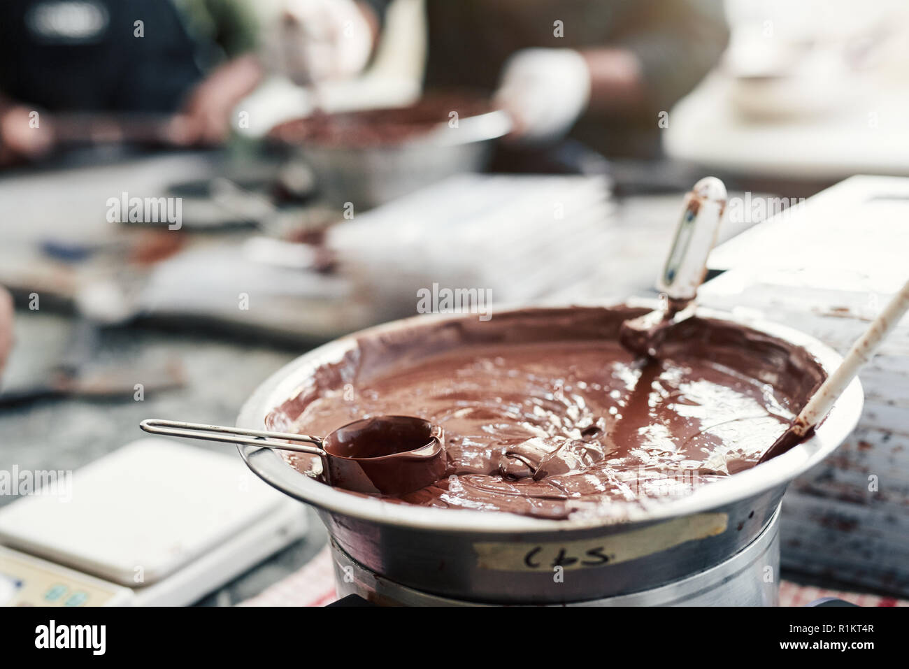 Chocolate being melted on a confectionary making factory table Stock ...
