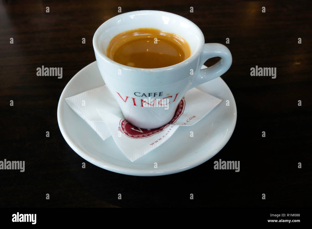 A cup of Vinci espresso coffee on a cafe table Stock Photo - Alamy
