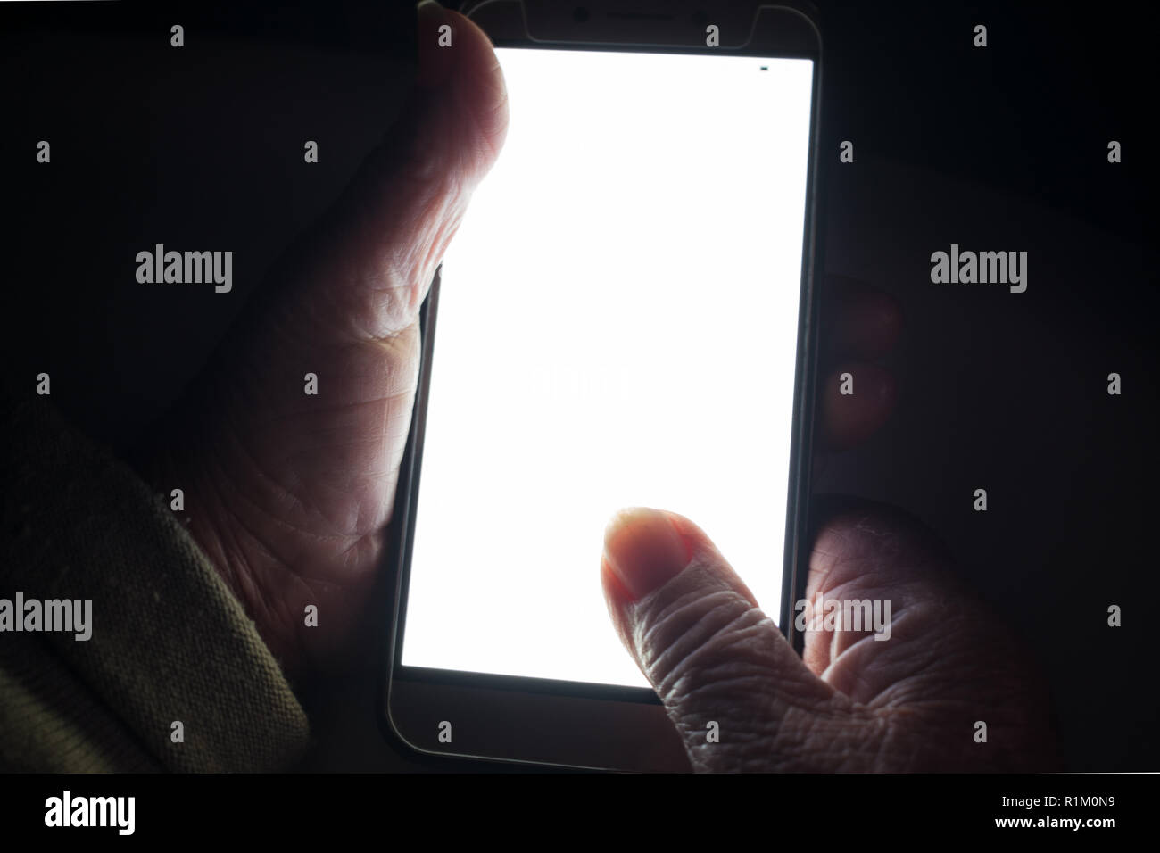 Senior person touching the screen of a smartphone Stock Photo - Alamy