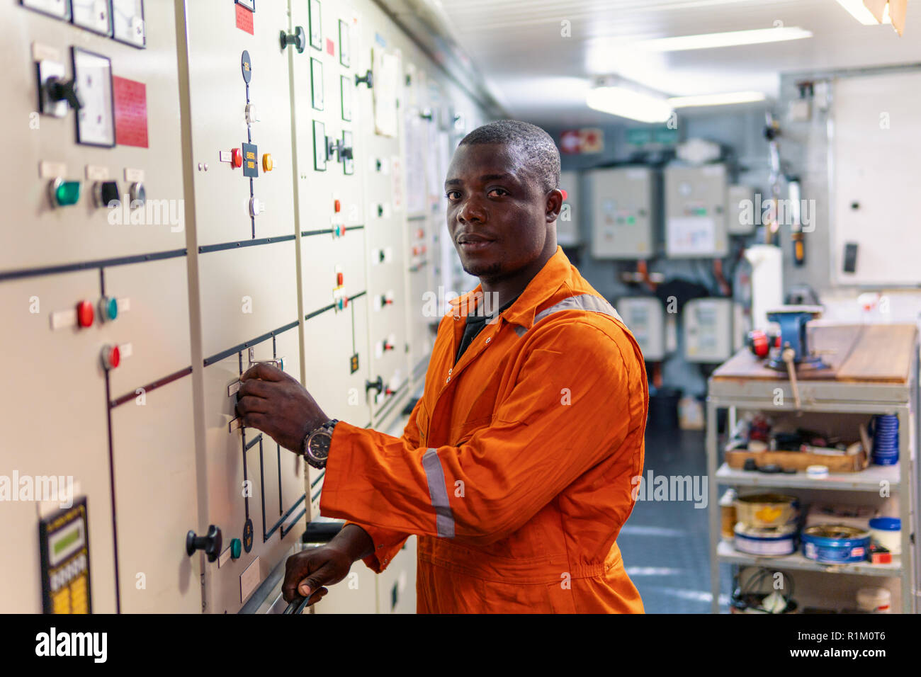 Marine engineer officer working in engine room Stock Photo - Alamy